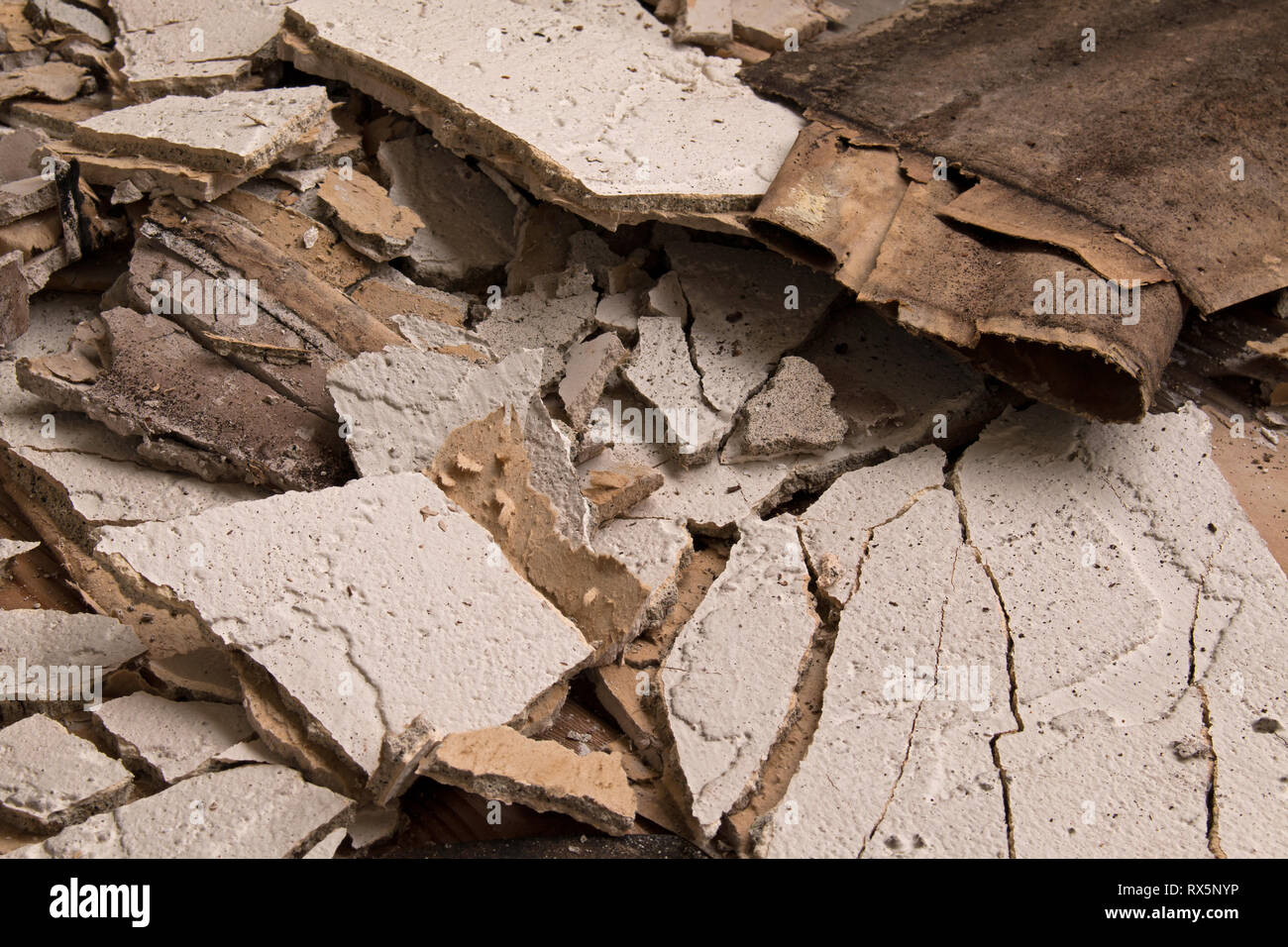 Pieces of broken stucco caused by water damage Stock Photo - Alamy