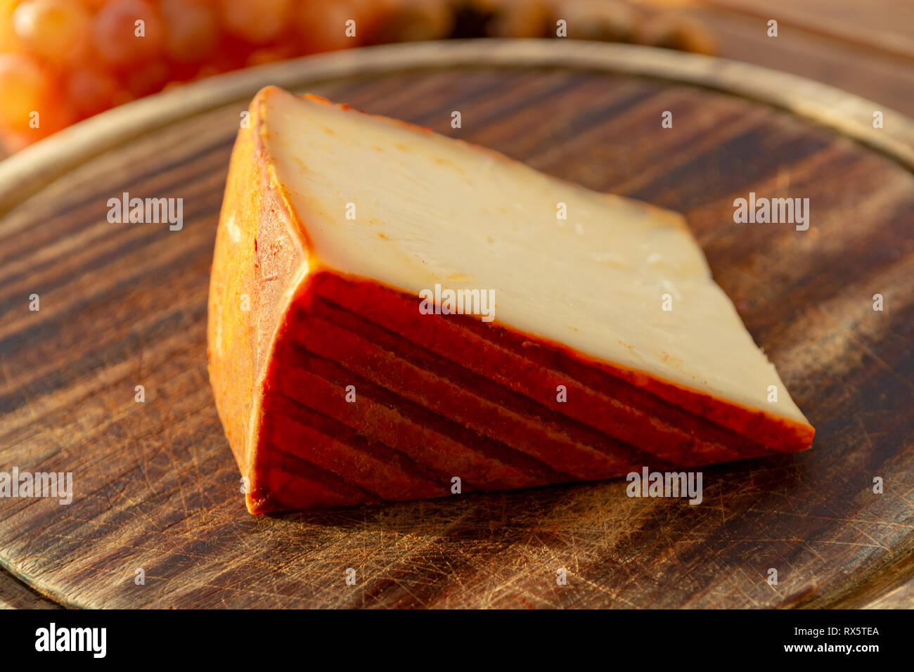 Spanish goat milk cheese with paprika coating and ripe pink table ...