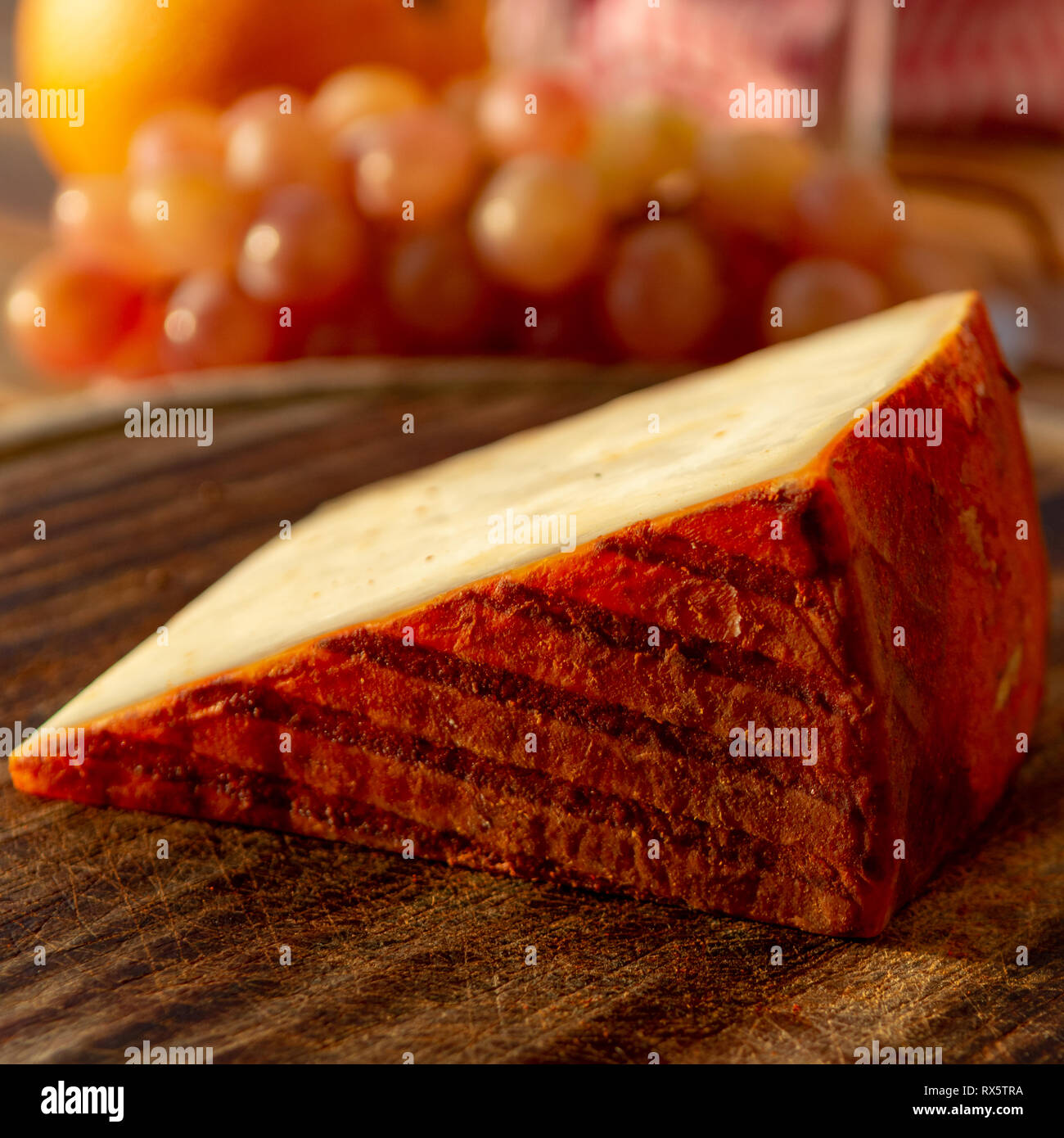 Spanish goat milk cheese with paprika coating and ripe pink table ...