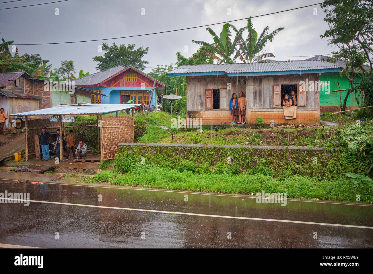 Asian kids waiting for the rain to stop. Flores is one of the Lesser ...