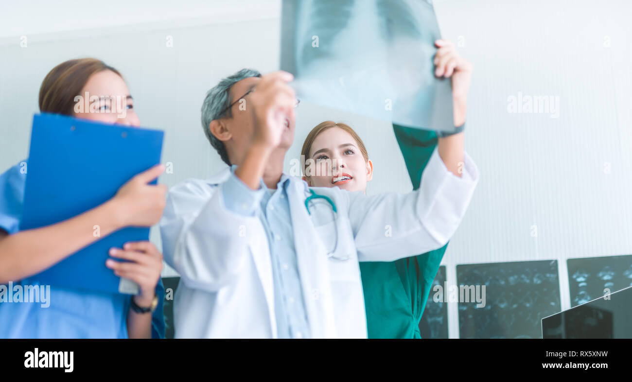 Medical doctors looking at x-rays in a hospital .checking chest x ray ...