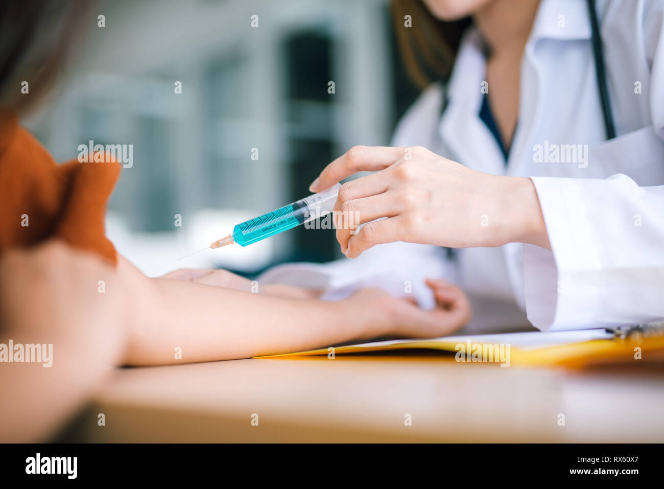Female doctor Injection to the patient. hand press syringe to inject ...