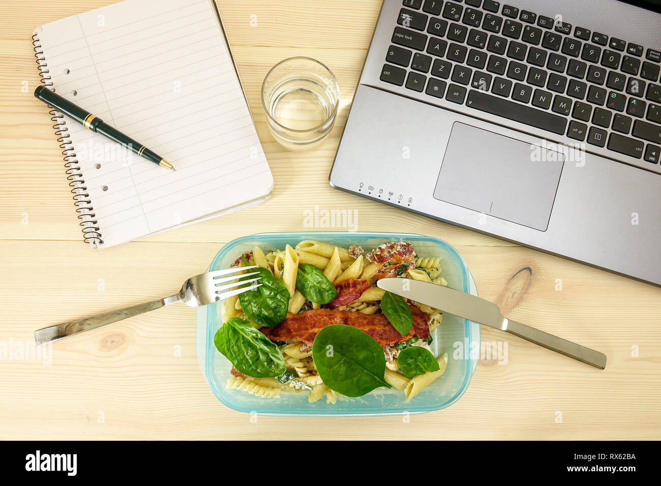 Quick Lunch. Lunch box in front of laptop. Concept of work overtime ...