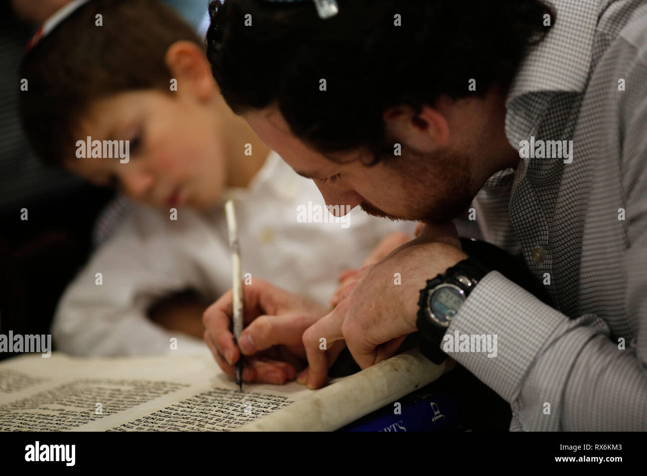 Modi'in, Israel. 8th Mar, 2019. An Orthodox Jew writes the last letters ...