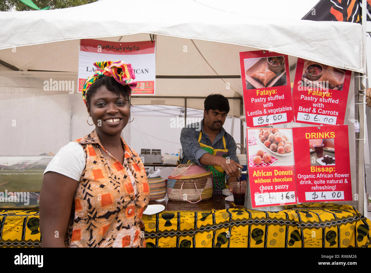 Smiling african woman at a food stall in sydney hi-res stock ...