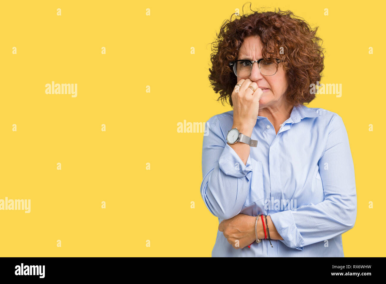 Beautiful middle ager senior businees woman wearing glasses over ...