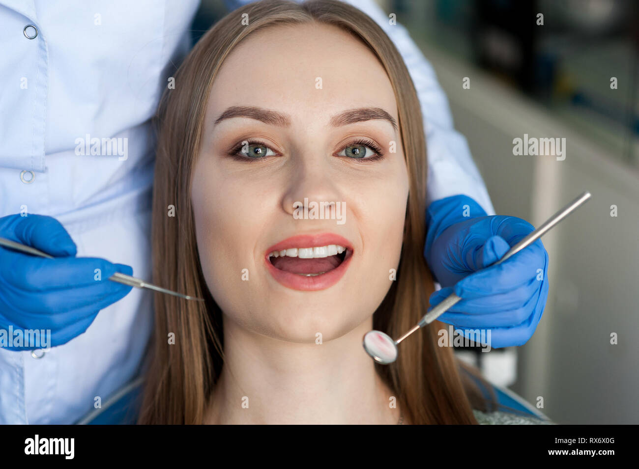 Dentist examining a patient's teeth in the dental clinic Stock Photo ...