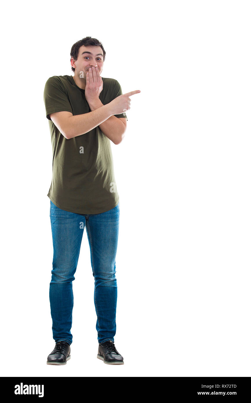 Full length portrait amused young man pointing finger showing something ...
