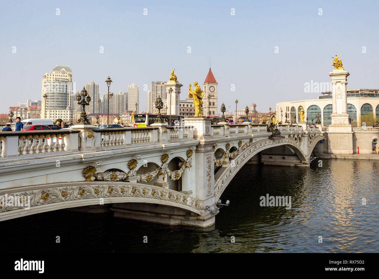 March 2014 - Tianjin, China - European style bridge with golden statues ...