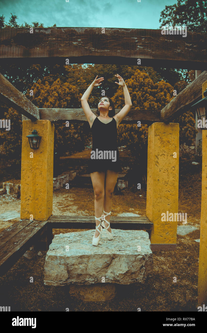 Young woman dancing in a garden Stock Photo - Alamy