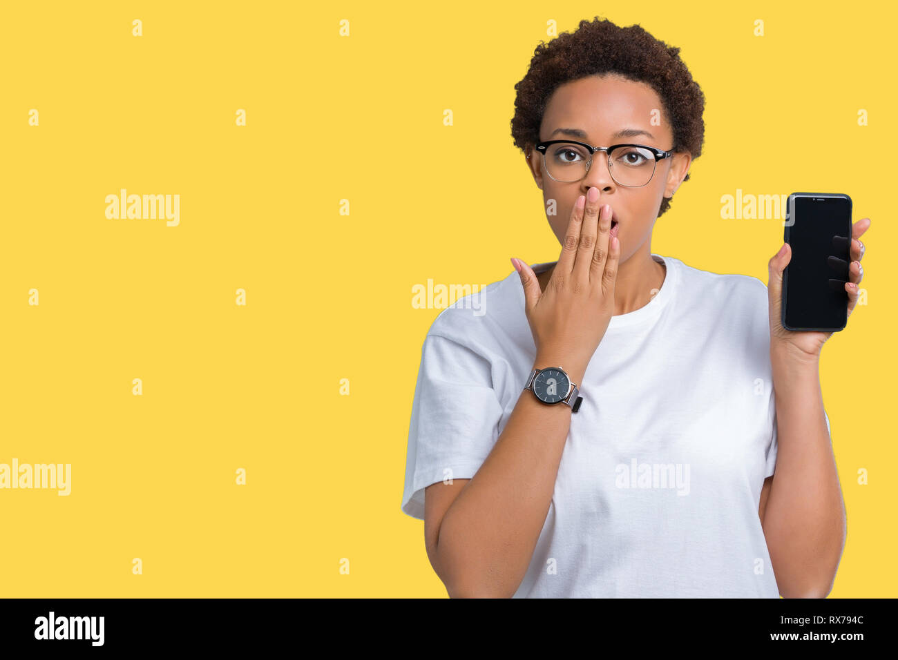 Young african american woman showing smartphone screen over isolated ...