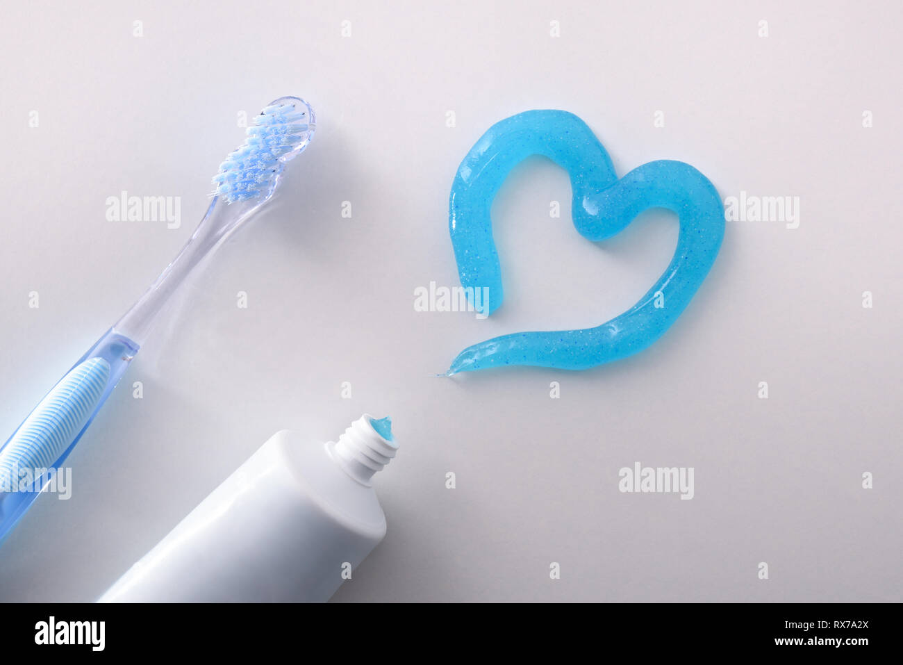 Dental health concept with toothbrush tube and toothpaste heart on ...