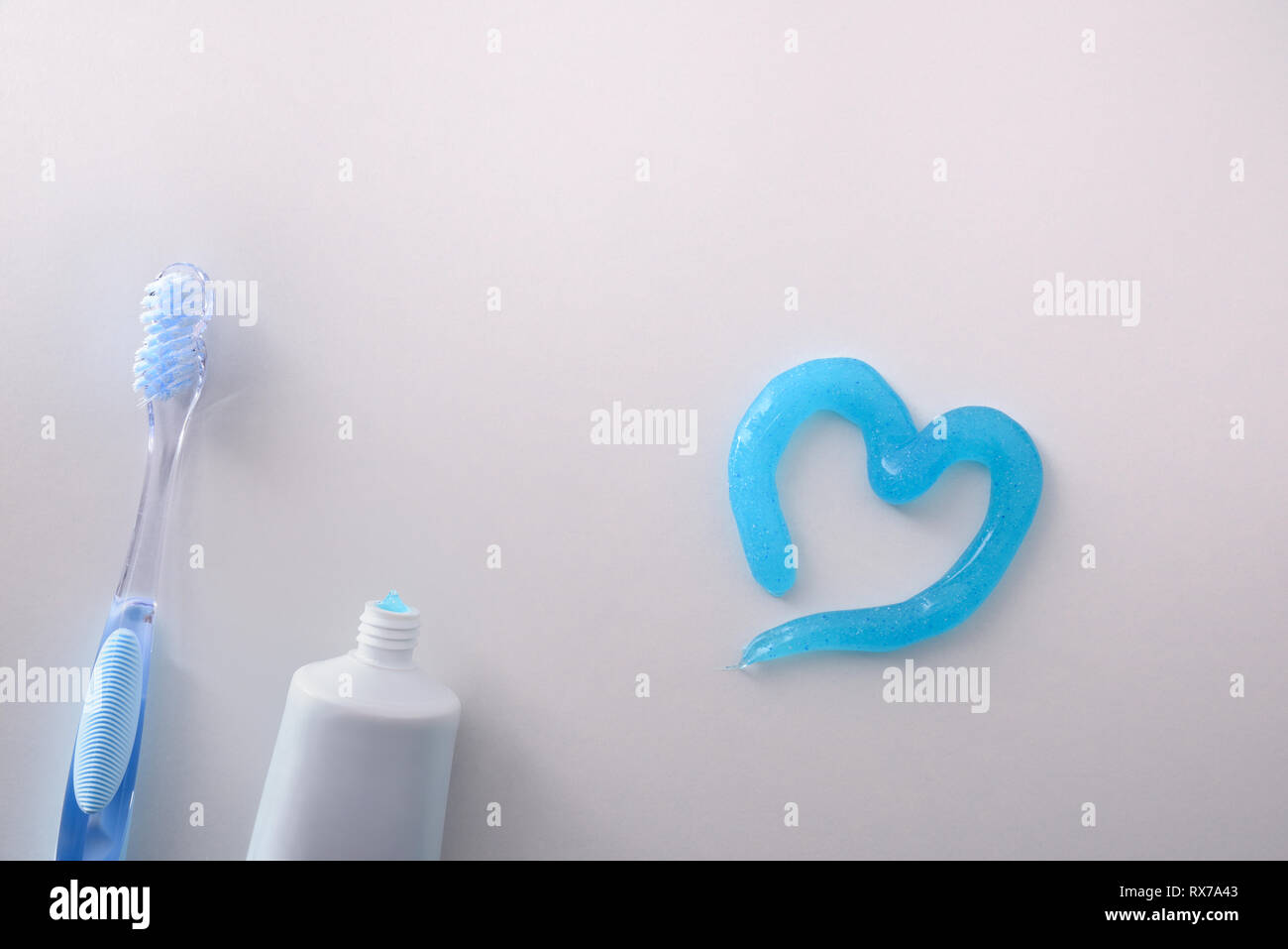 Dental health concept with toothbrush tube and toothpaste heart on ...