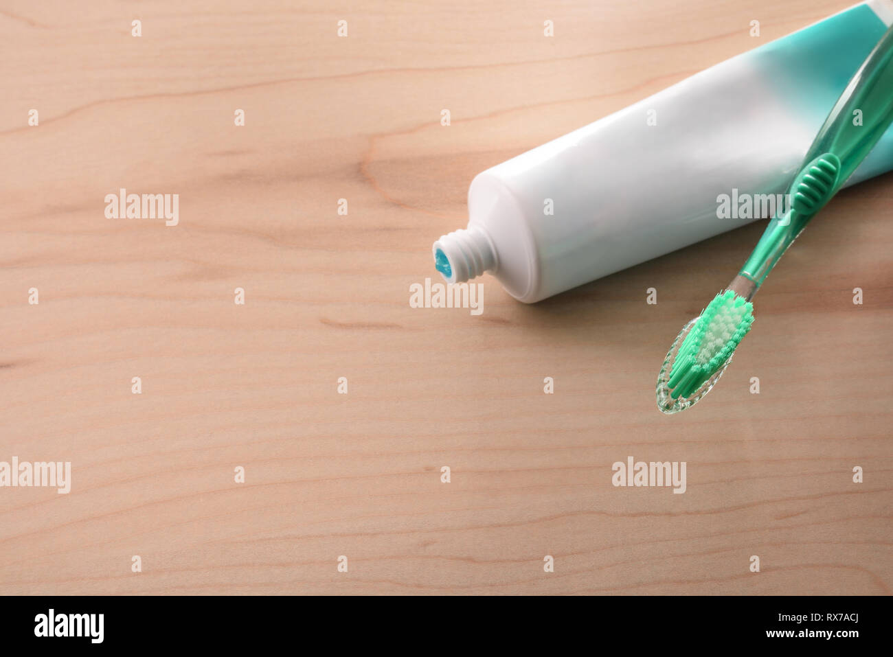 Toothbrush and toothpaste on wood table dental hygiene concept ...