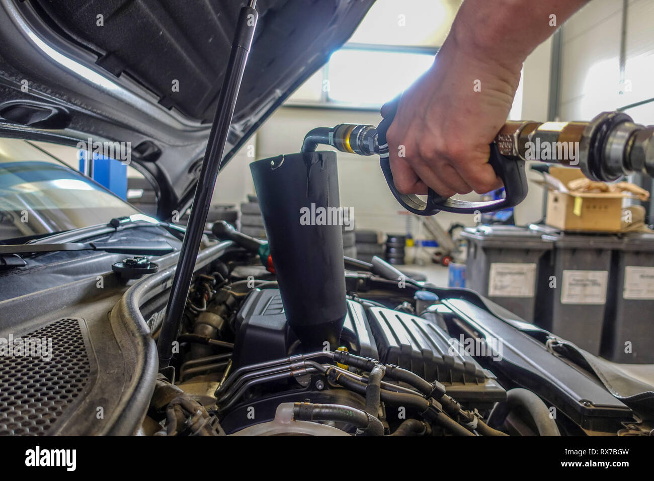 Engine oil is filled into a car engine Stock Photo - Alamy