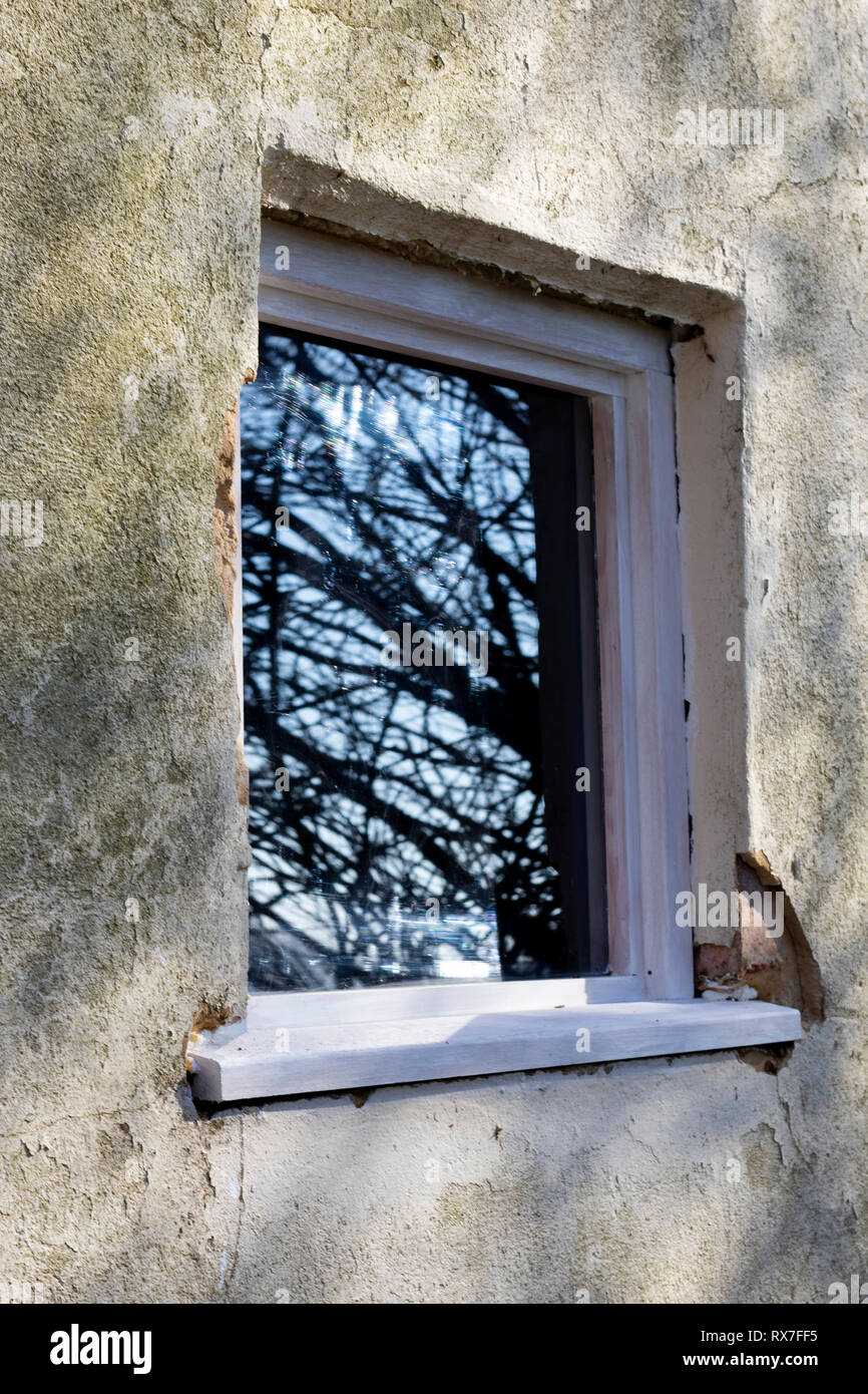 UPVC white window on derelict building awaiting demolition with ...