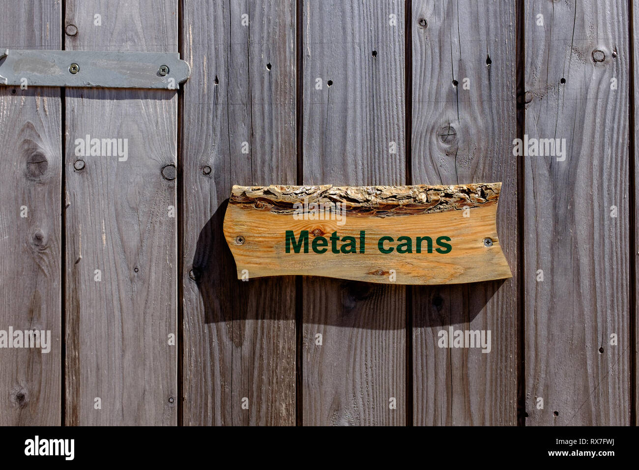 Recycling building with hand carved wooden information signs attached ...