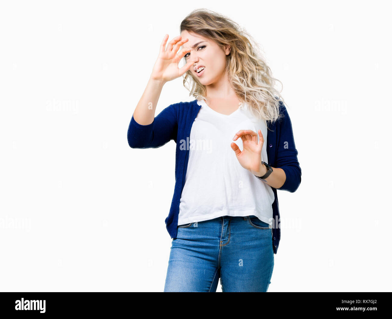Beautiful young blonde woman over isolated background disgusted ...