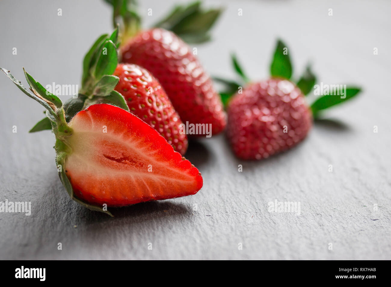 Fresh red strawberries on a black stone table Stock Photo - Alamy