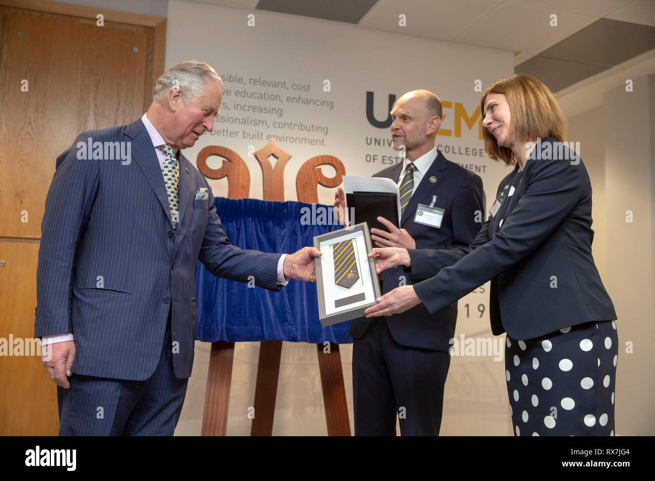 The Prince of Wales receives a tie from Deputy Principal Jame Fawkes ...