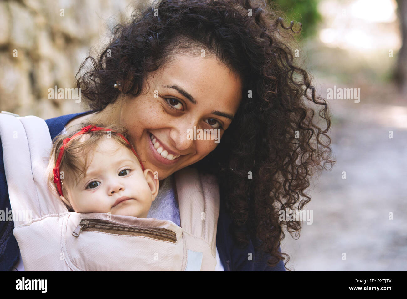 Mother carrying child walking hi-res stock photography and images - Alamy