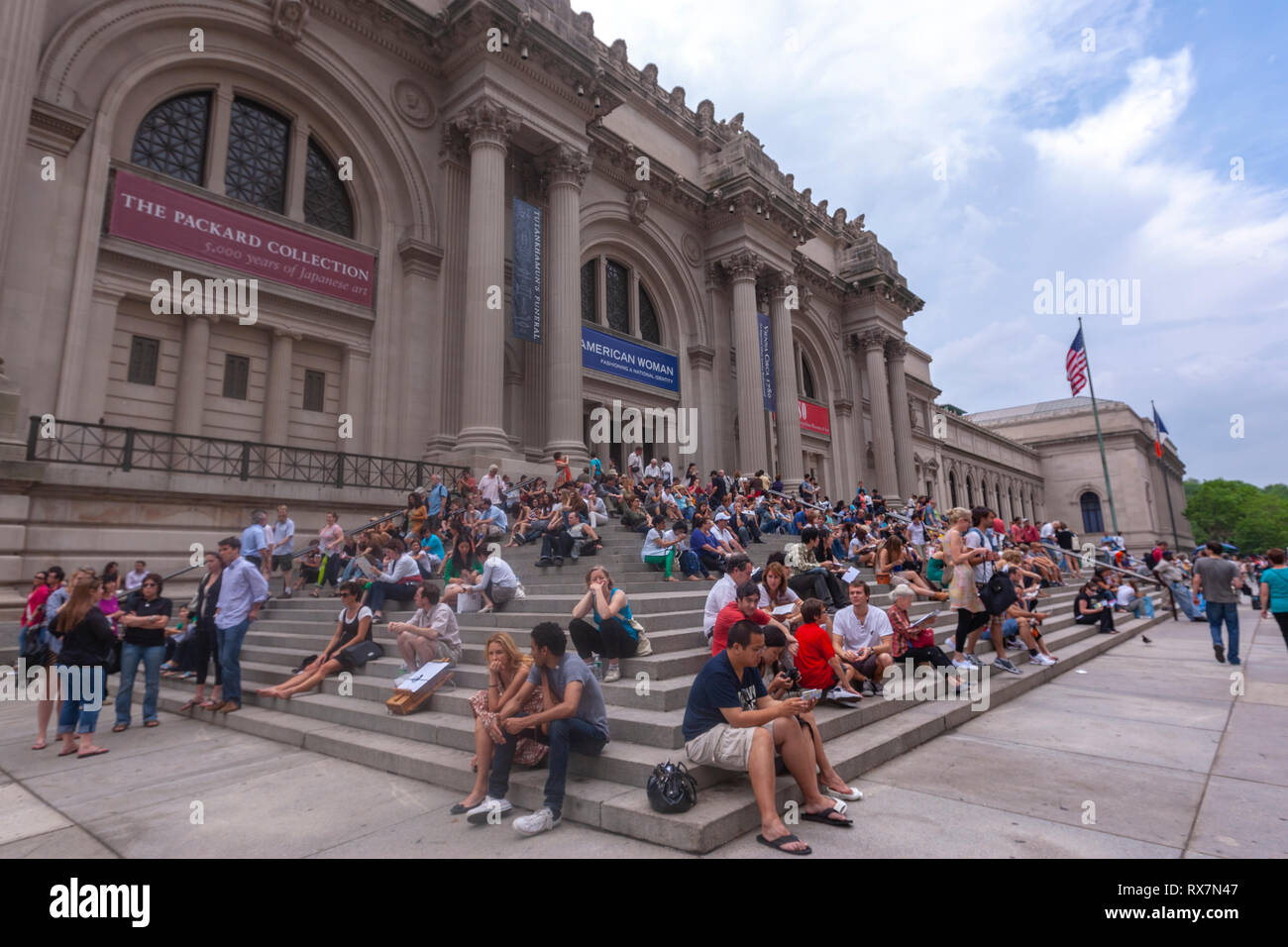 Visitors seated in the steps entrance of the The Metropolitan Museum of ...