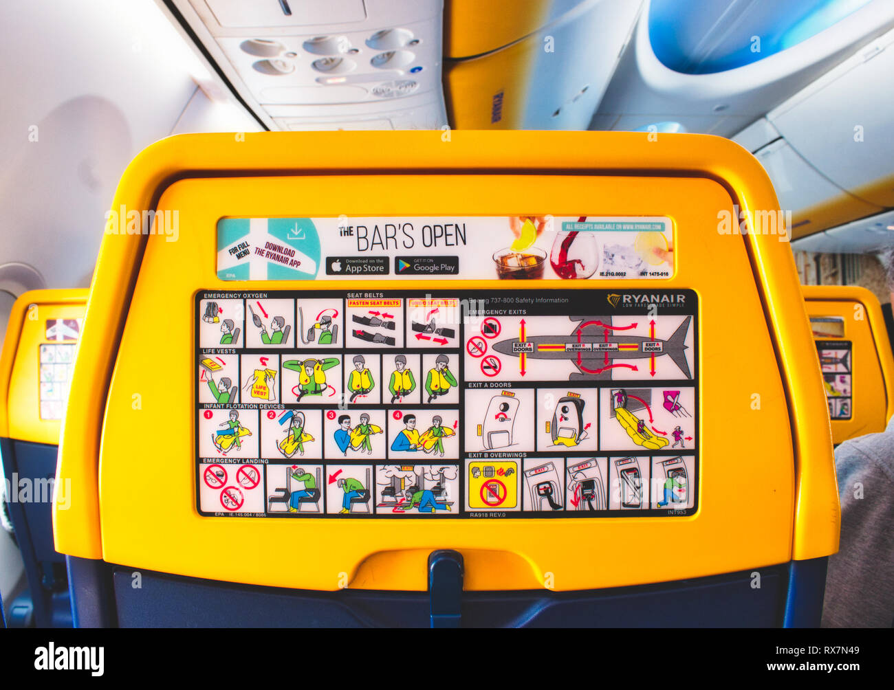 Airplane safety card and seatback screen with Ryanair branding and bar ...