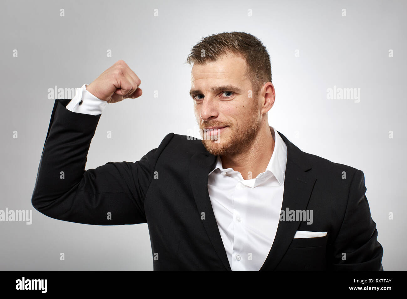 Strong business concept with businessman flexing biceps Stock Photo - Alamy