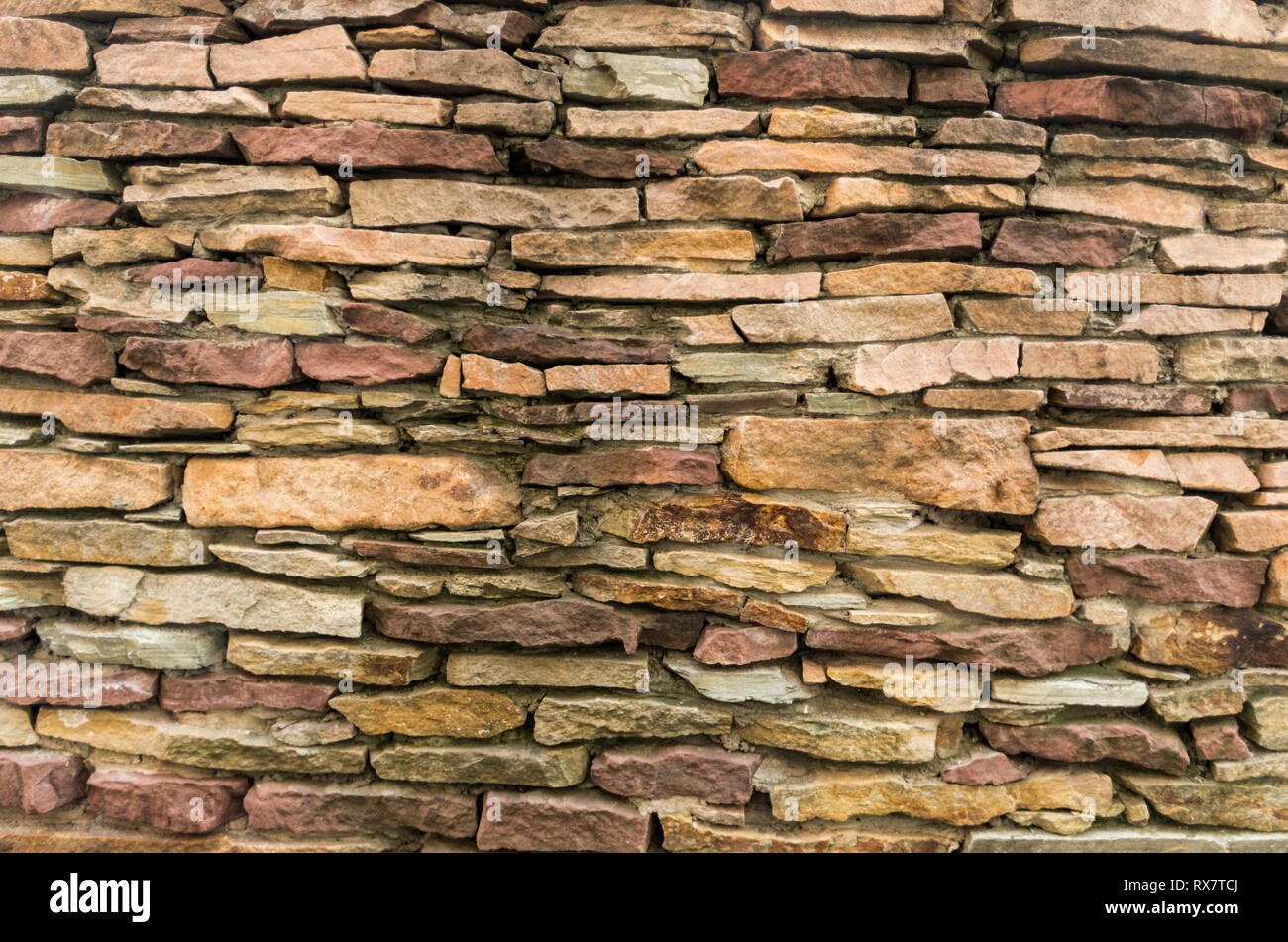 A wall of small stones. Texture of yellow stones. Stony background ...