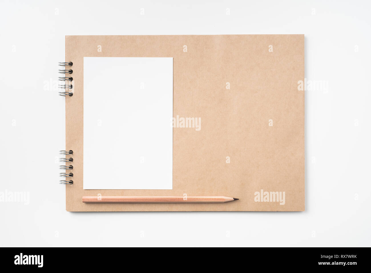 Design concept - Top view of kraft notebook, photo frame and pen ...