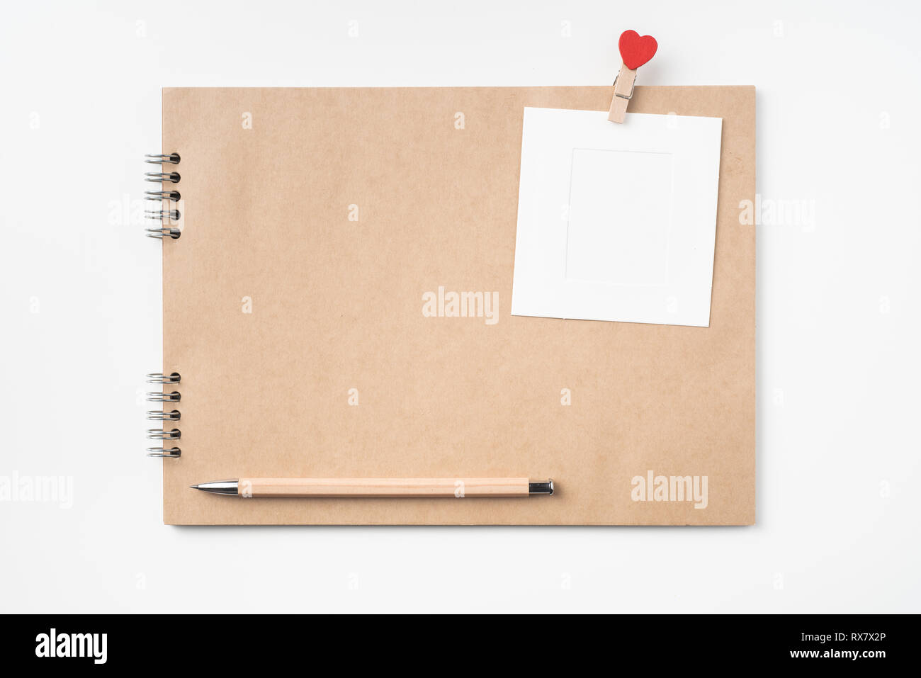 Design concept - Top view of kraft notebook, photo frame and pen ...