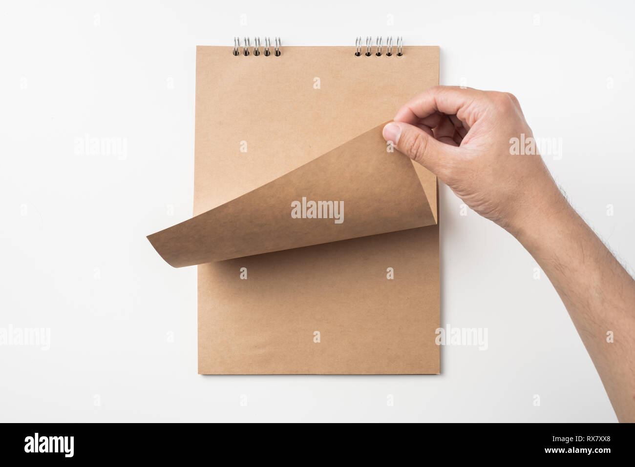 Design concept - Top view of man's hand turn up kraft page isolated on ...