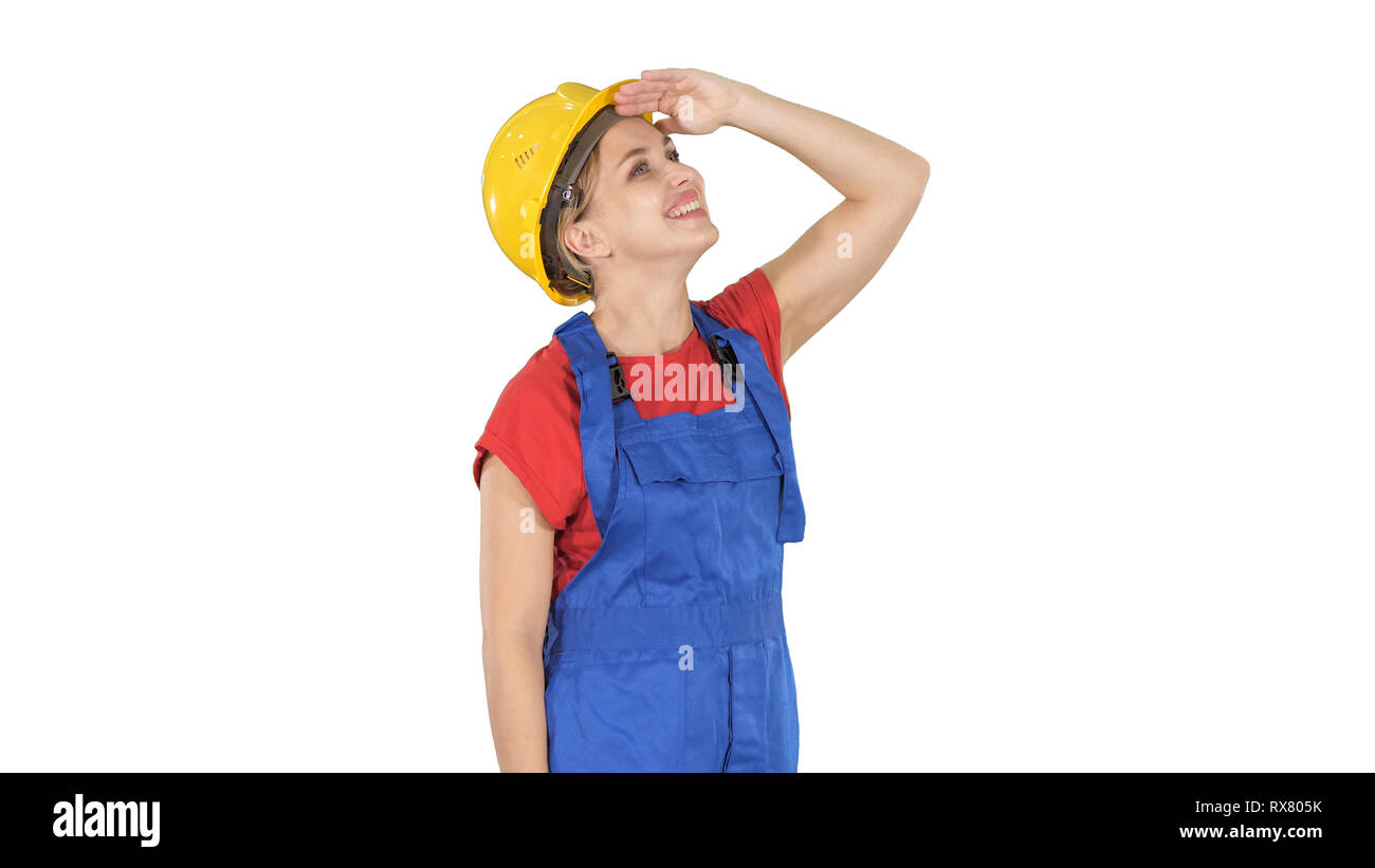 Medium shot. Side view. Engineer construction worker woman looking up ...