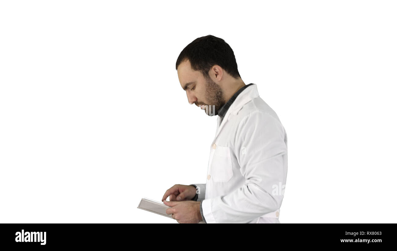 Medium shot side view. Portrait of male doctor walking and using ...