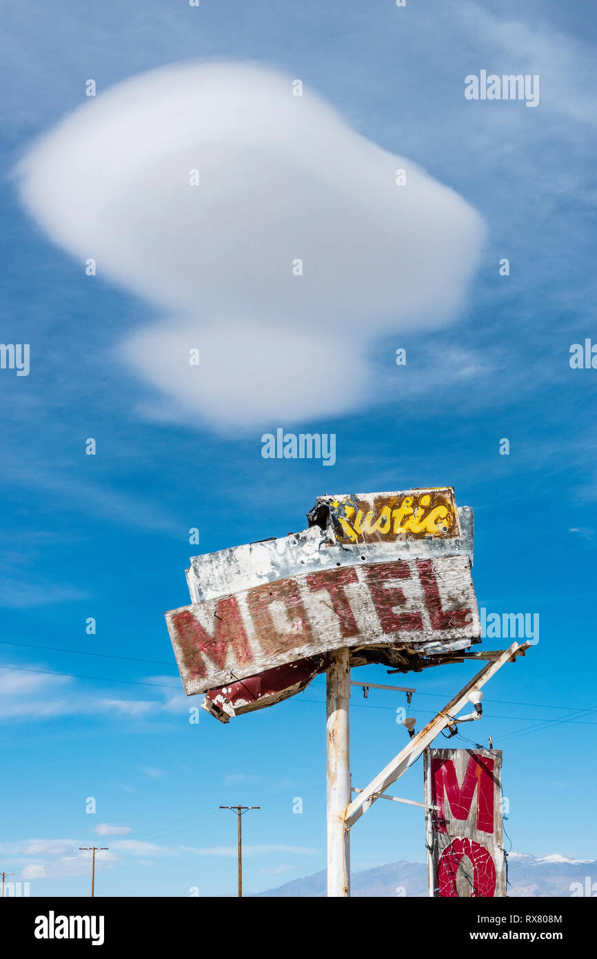 The Rustic Oasis Motel sign with a lenticular cloud formation behind it ...