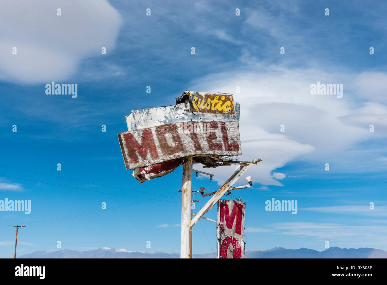 The Rustic Oasis Motel sign with a lenticular cloud formation behind it ...