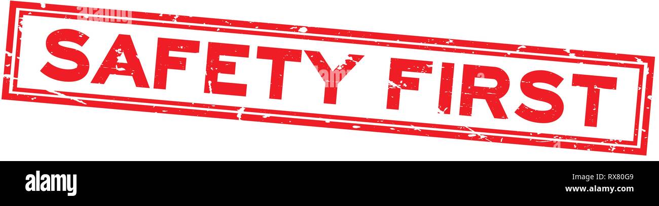 Grunge red safety first word square rubber seal stamp on white ...