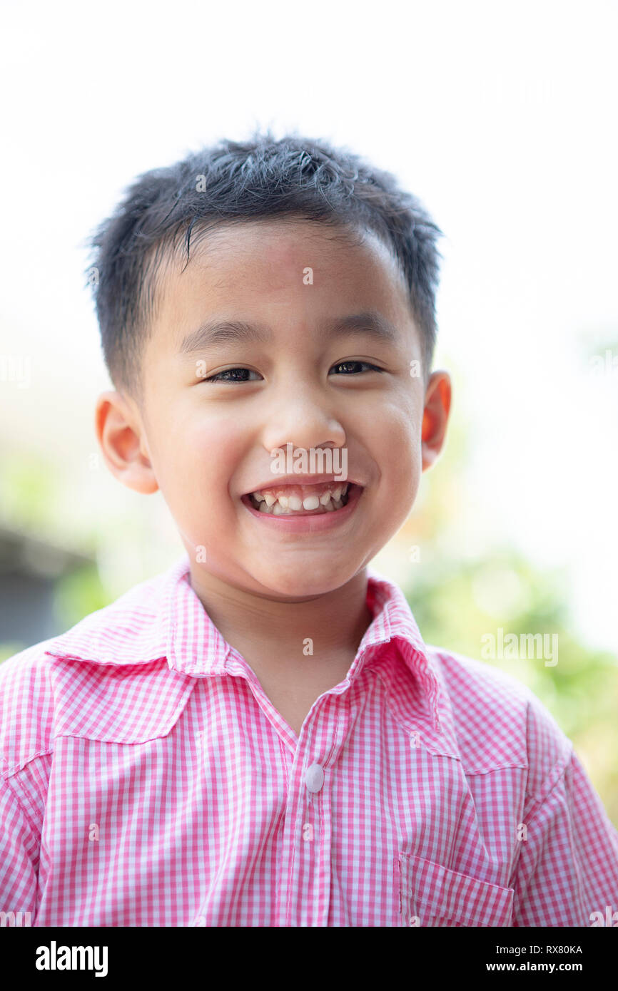 close up headshot of cheerful asian children toothy smiling face of ...