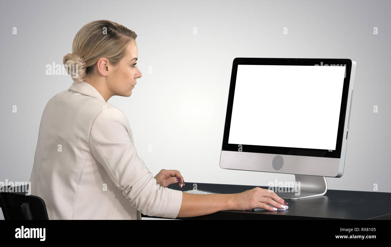 Back view to the monitor of the computer. Young woman working in office ...