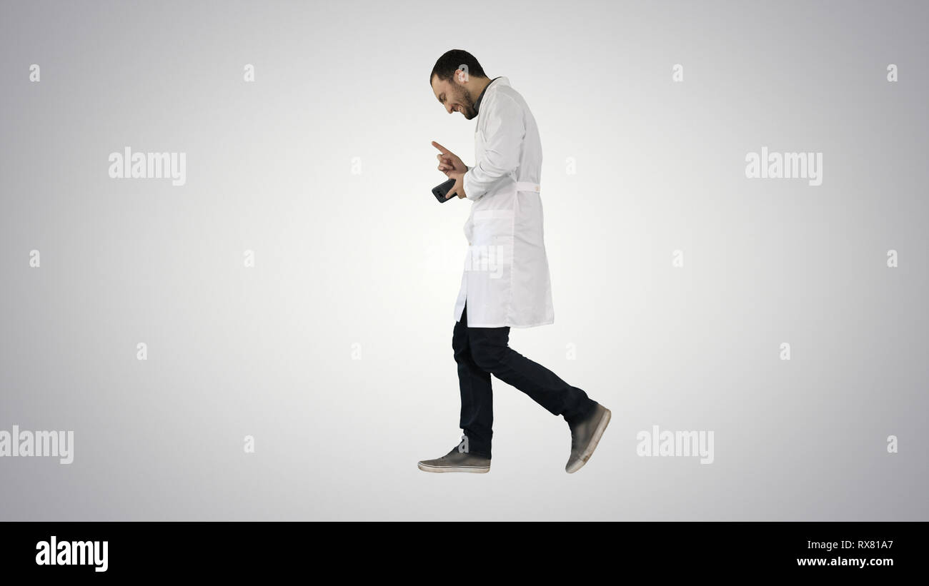 Full length portrait side view. Walking attractive laughing doctor on ...