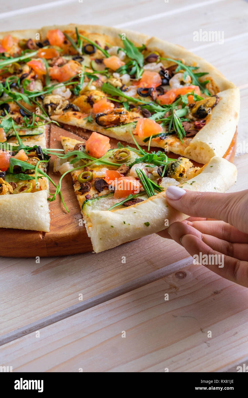 Hand take pizza hi-res stock photography and images - Alamy