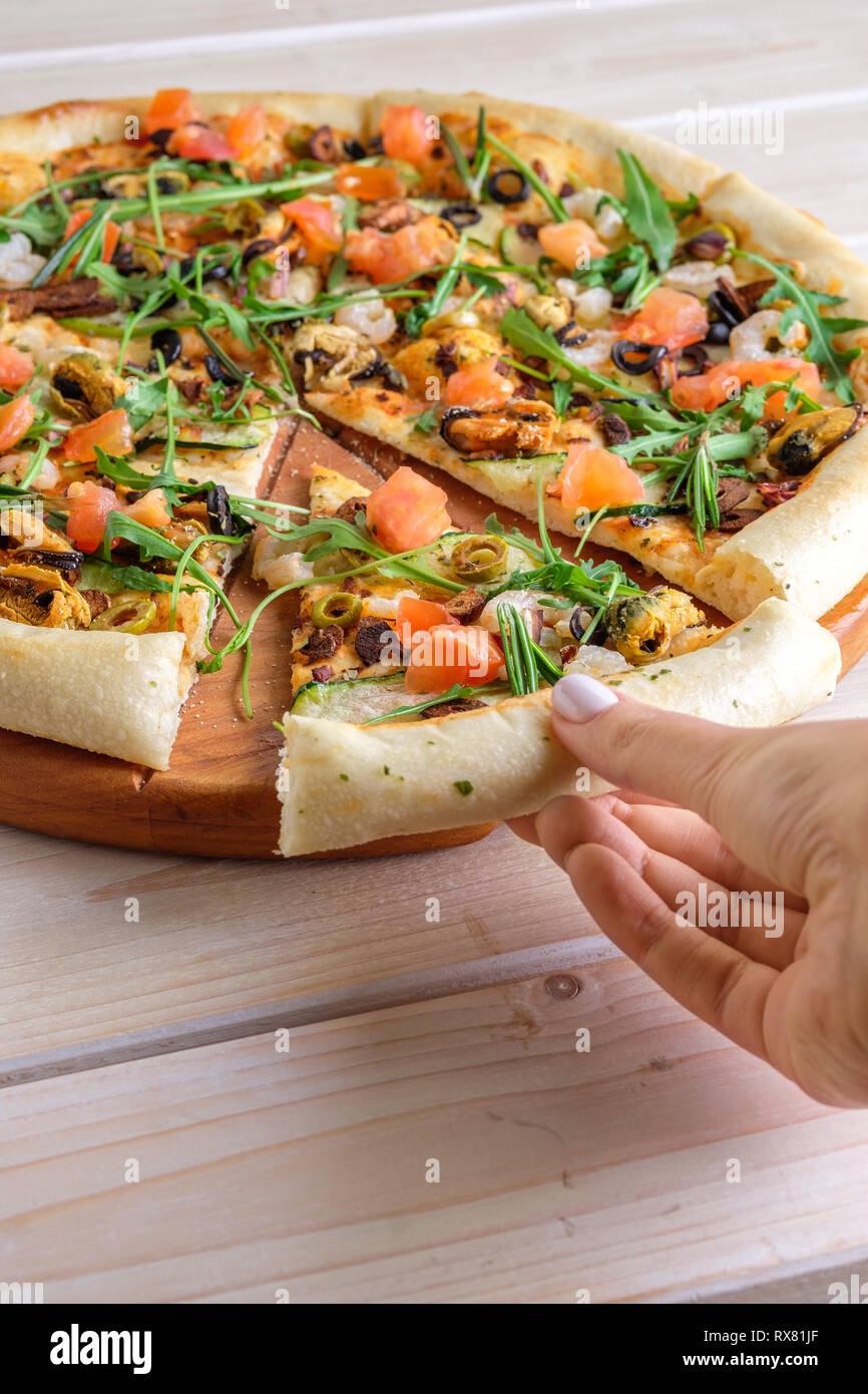 Hand take pizza hi-res stock photography and images - Alamy