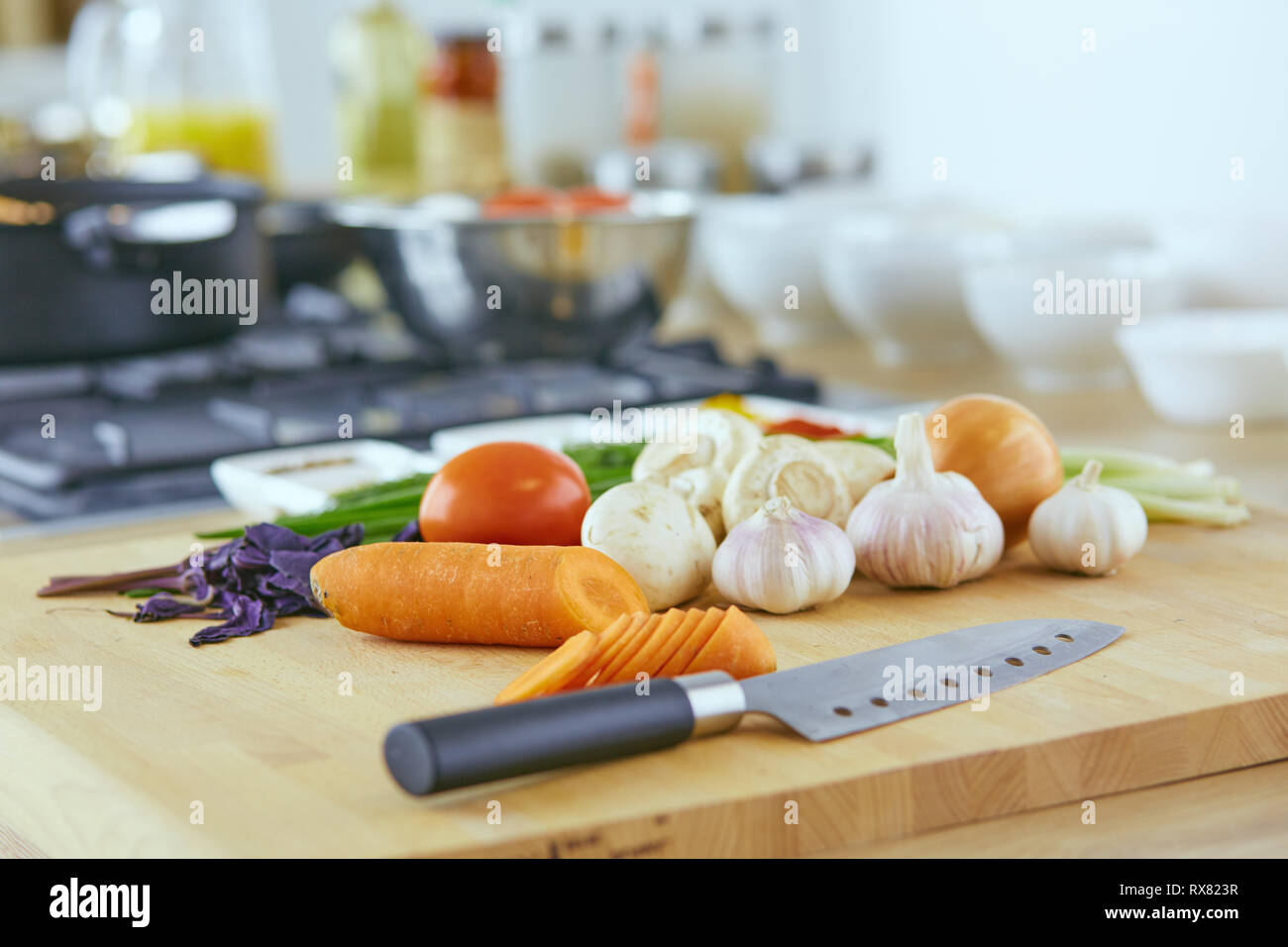 Composition with wooden board and ingredients for cooking on table ...