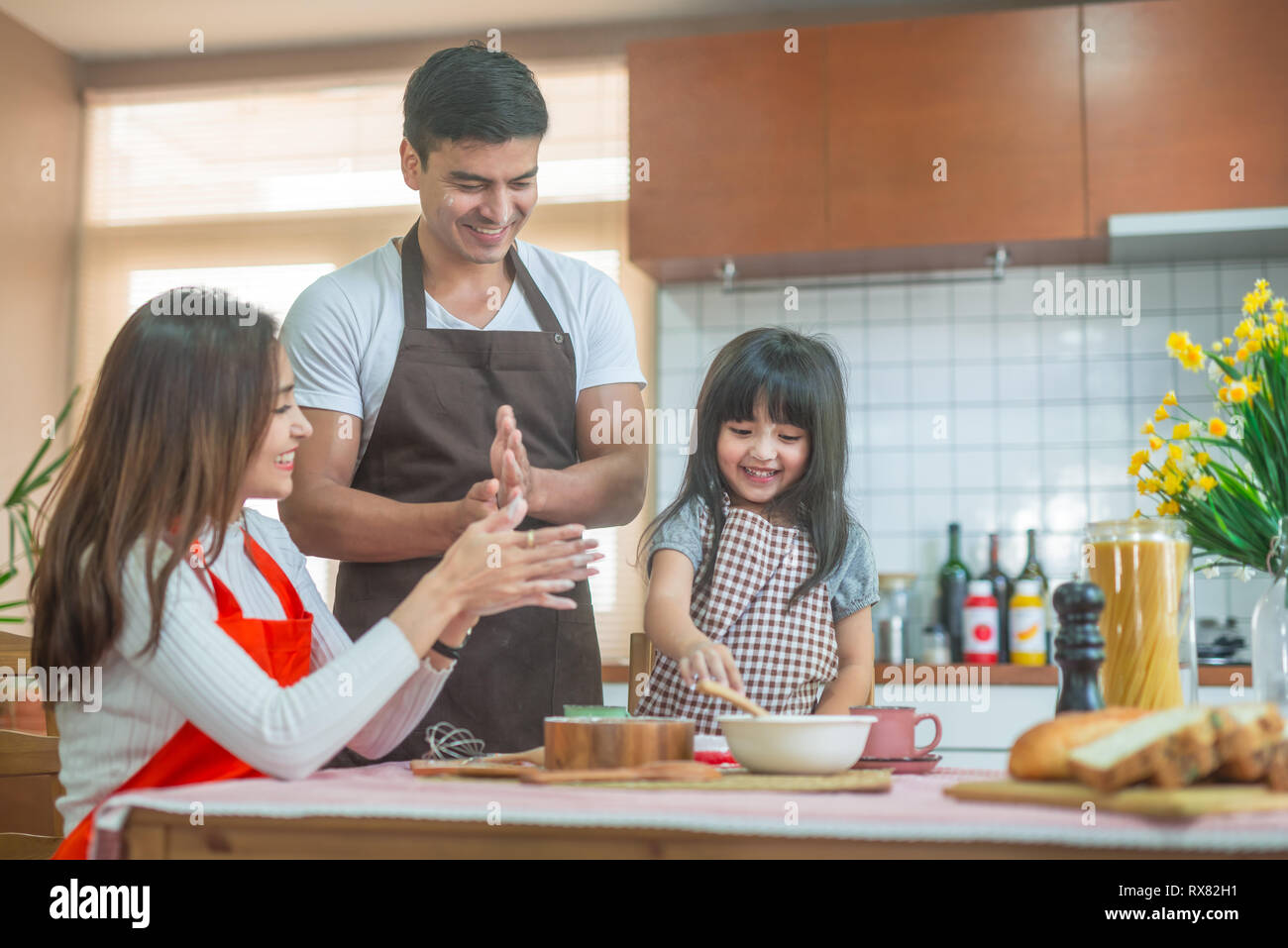 Daughter and parent preparing the bake Family concept Stock Photo - Alamy