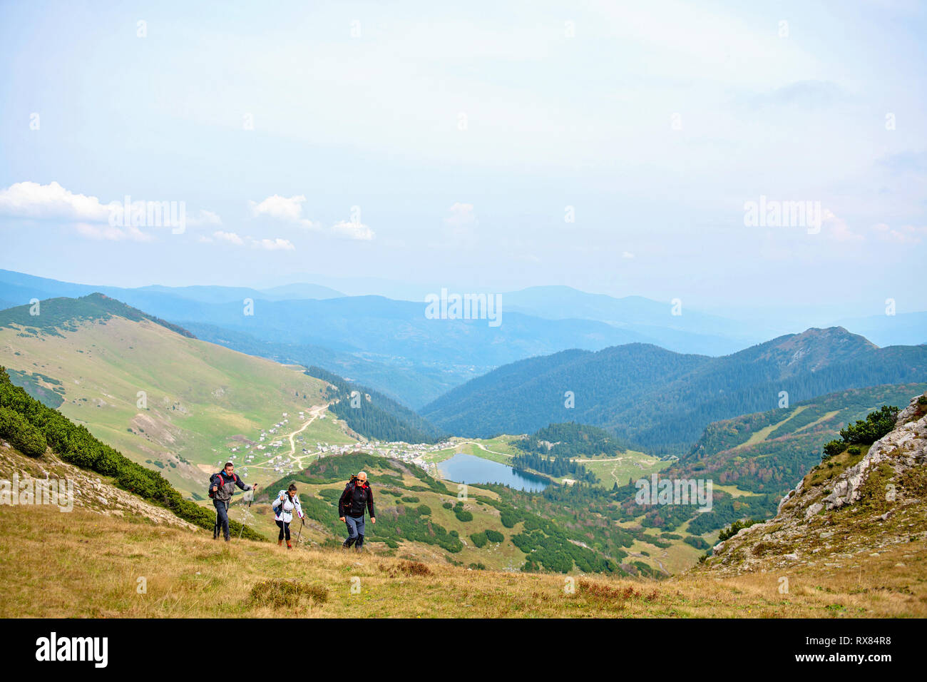 An elderly man giving a tour for a young group of people Stock Photo ...
