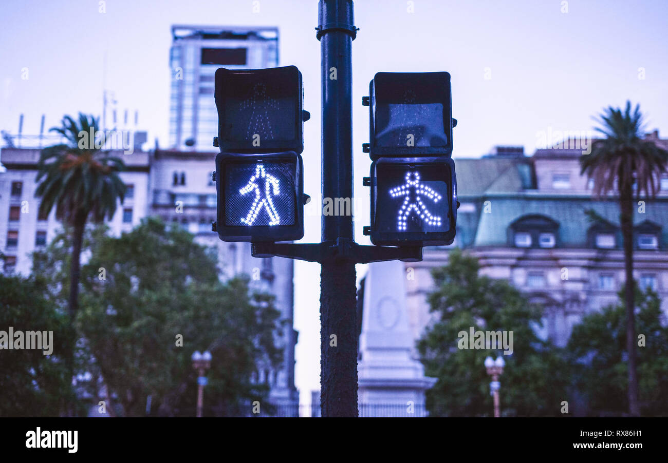 Two traffic lights giving the pedestrians the signal that they can ...