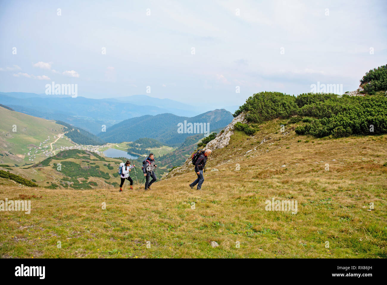 An elderly man giving a tour for a young group of people Stock Photo ...