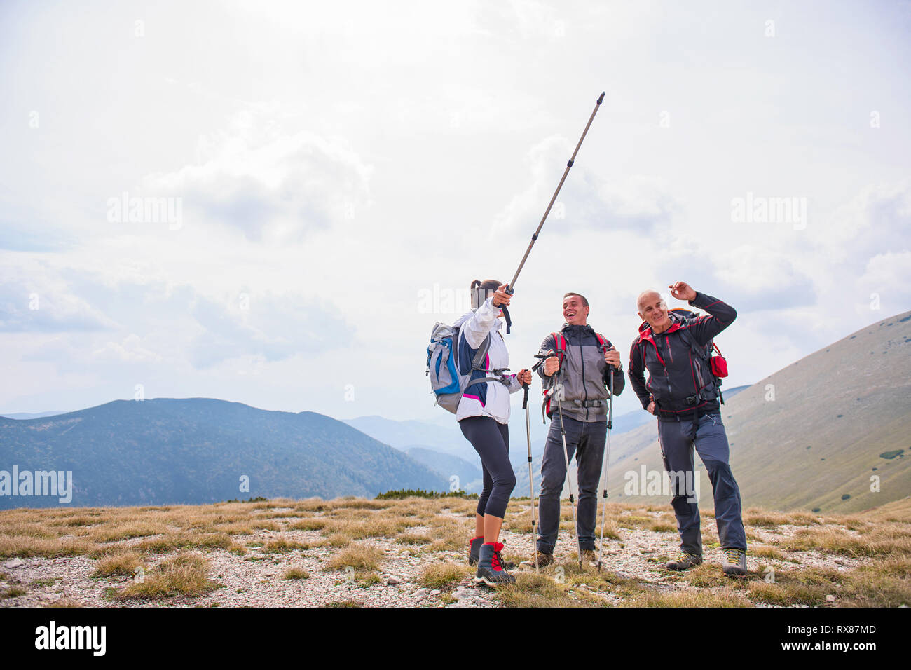 An elderly man giving a tour for a young group of people Stock Photo ...