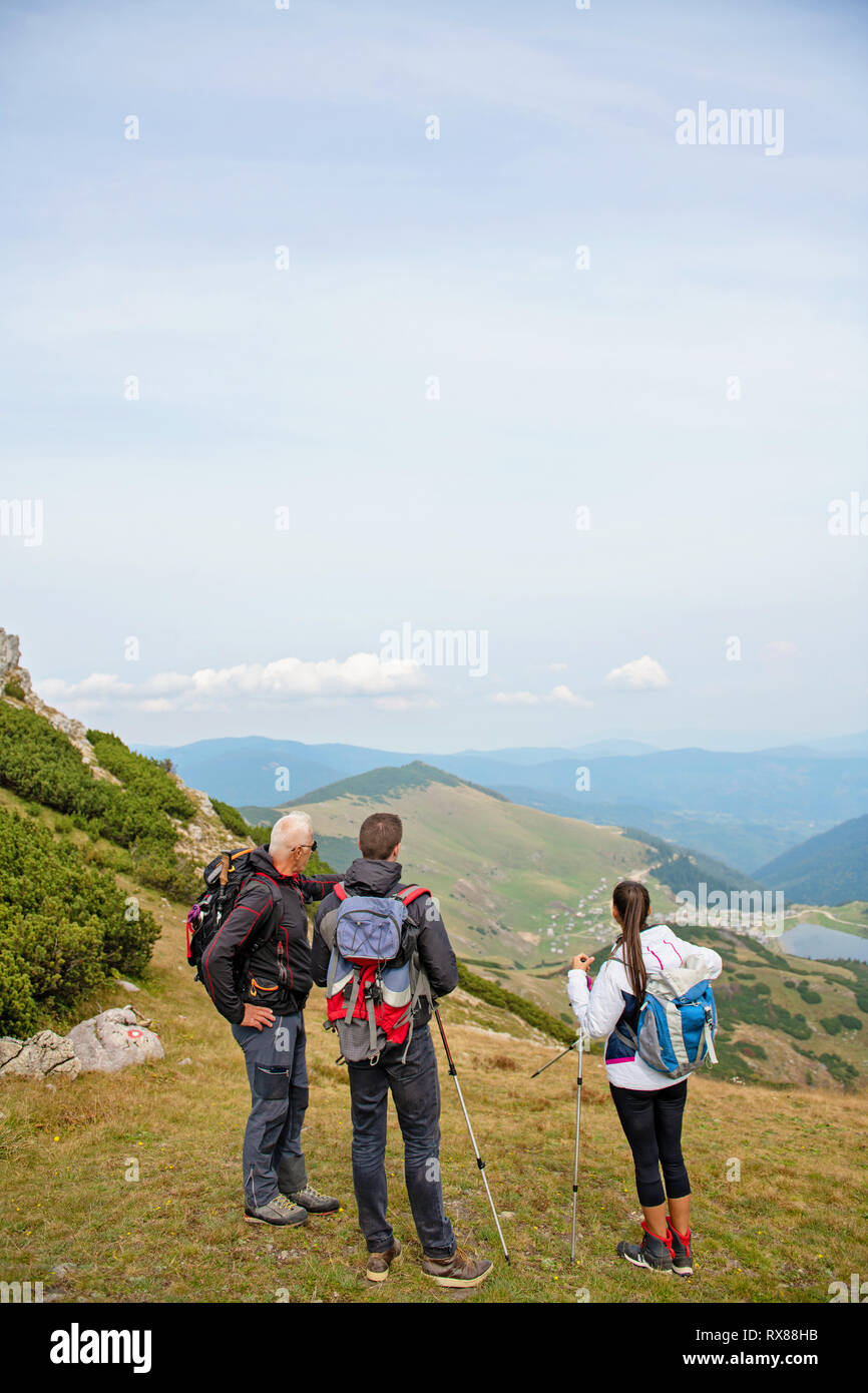 An elderly man giving a tour for a young group of people Stock Photo ...