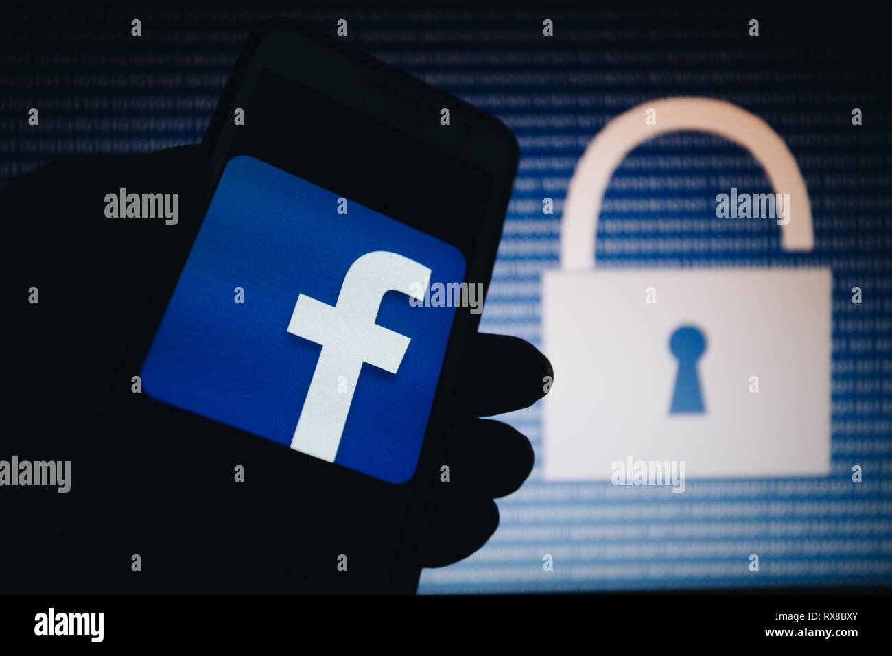 Facebook icon, logo is shown on smartphone display, open lock, numbers ...